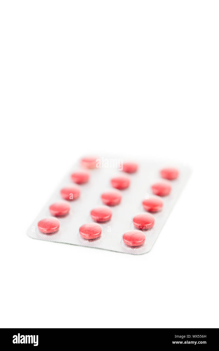 Red pills against white background Stock Photo - Alamy