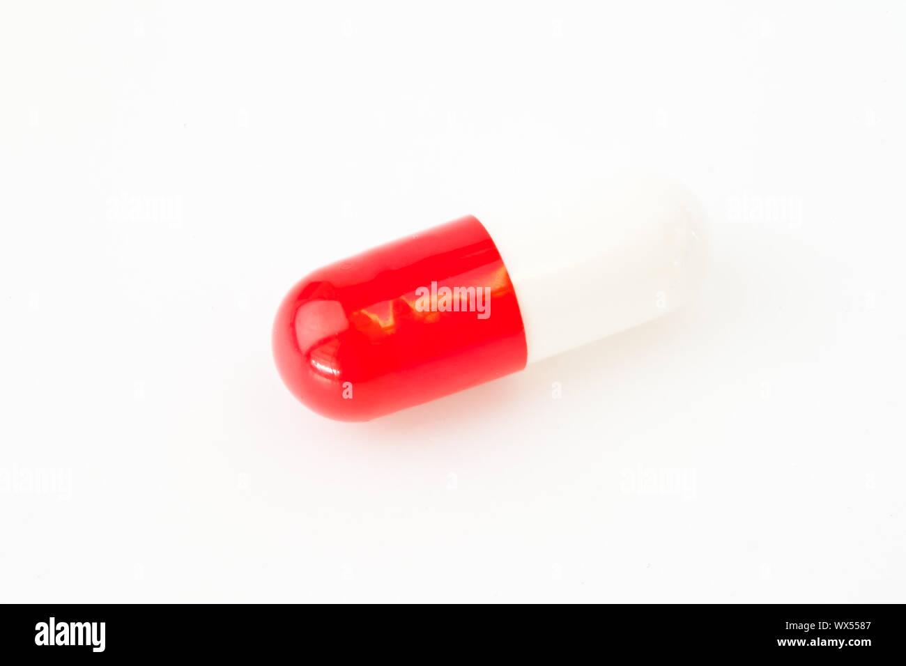 Capsule against white background Stock Photo - Alamy