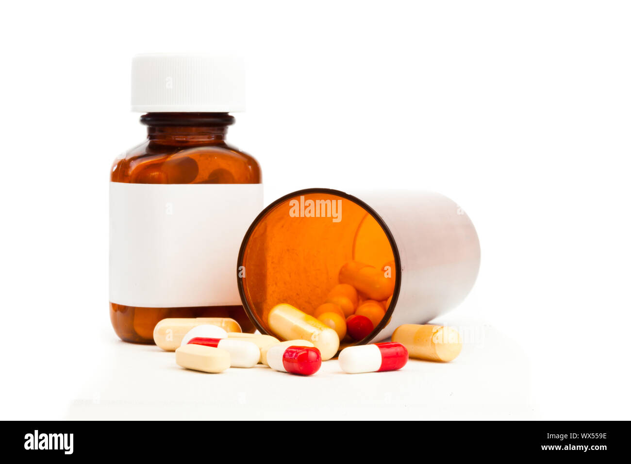 Container of medications knocked over against white background Stock ...