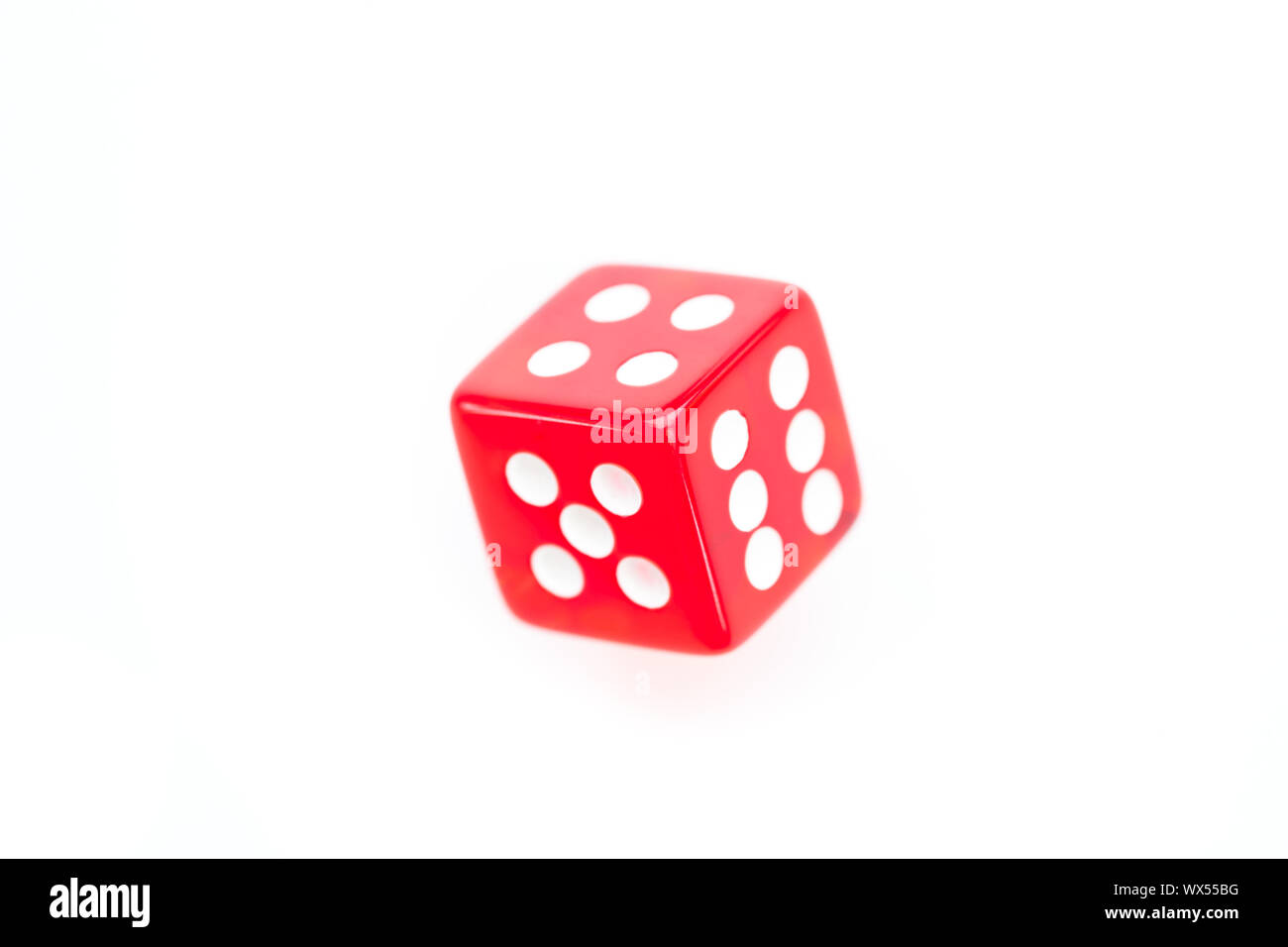 Red dice in motion against a white background Stock Photo - Alamy