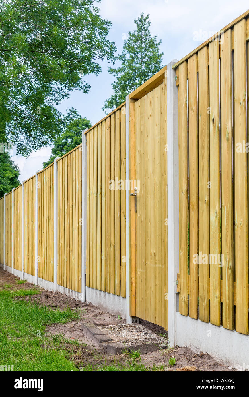 New wooden fence construction in backyard Stock Photo - Alamy