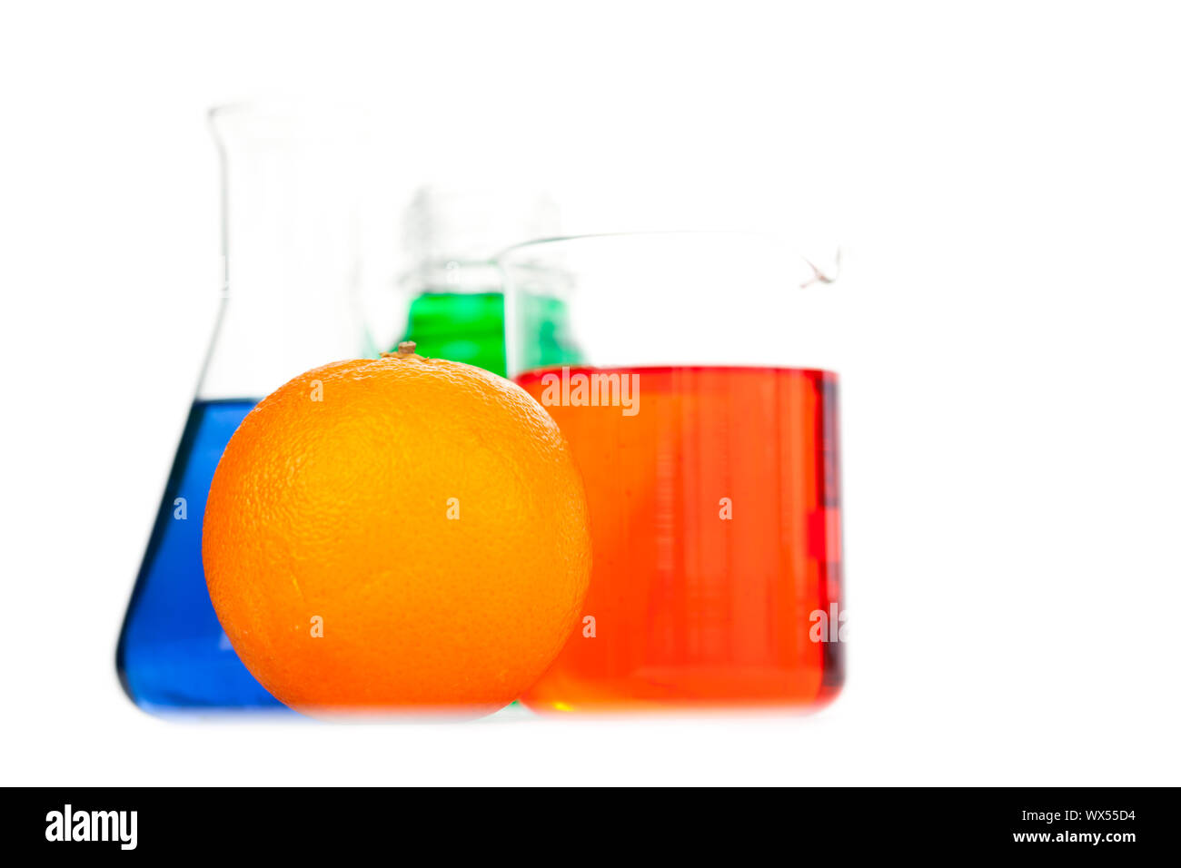 Orange next to beakers against a white background Stock Photo - Alamy