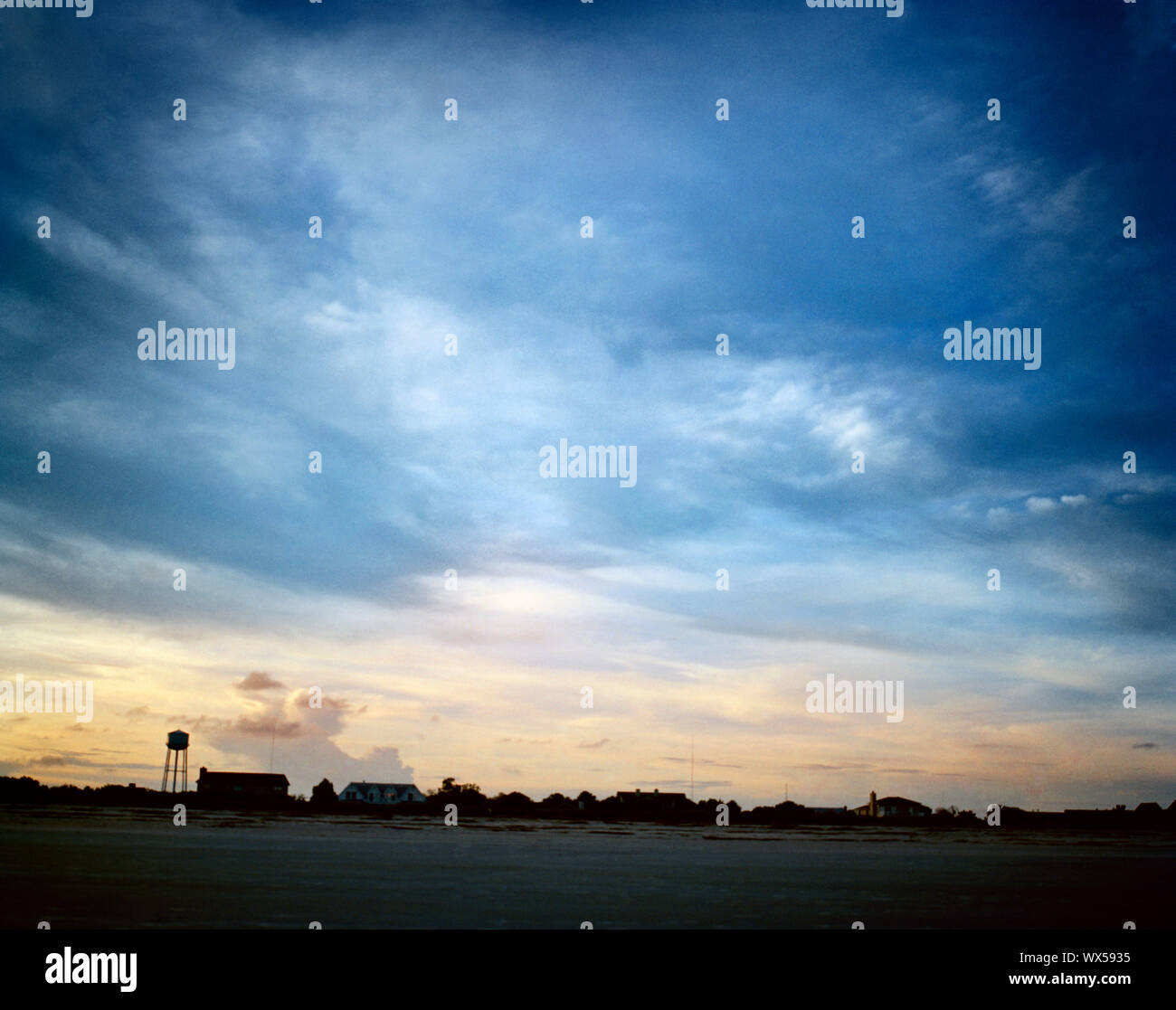 Cloudy blue sky above a town Stock Photo - Alamy