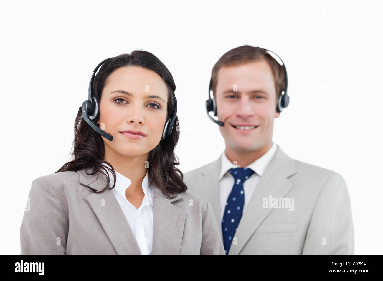 Young call center agents standing together against a white background ...
