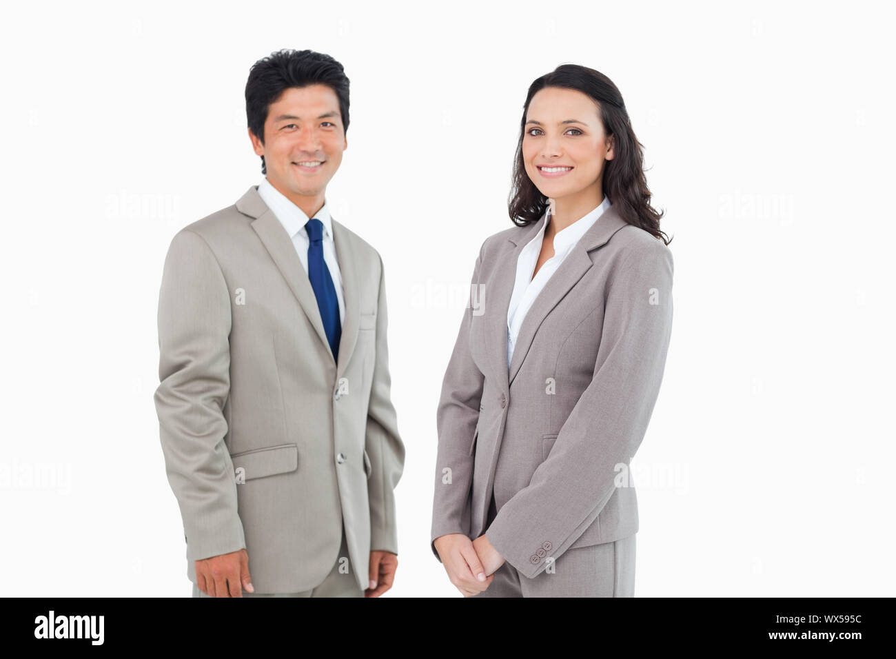 Young business partners standing together against a white background ...