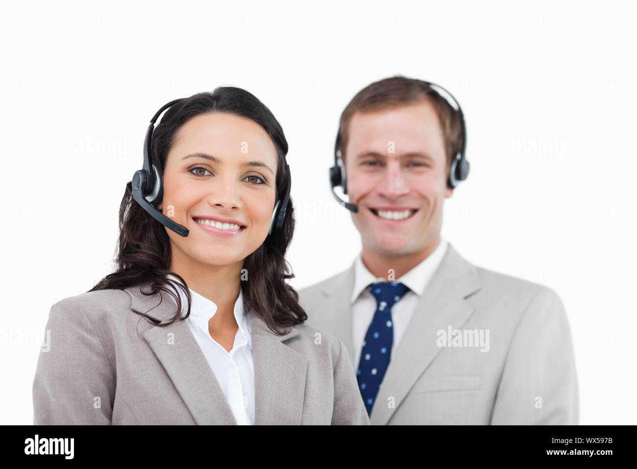 Smiling call center agents standing together against a white background ...