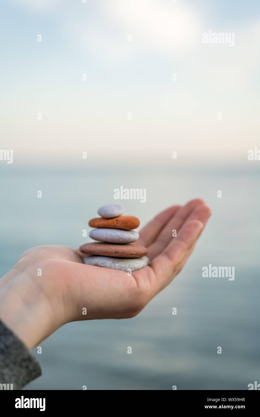 Pile of stacked stones in human hand Stock Photo - Alamy