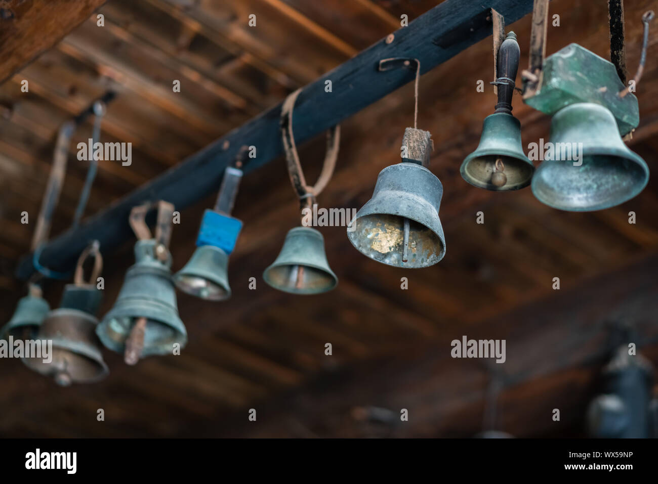 Small brass bells hanging in the cellar Stock Photo - Alamy