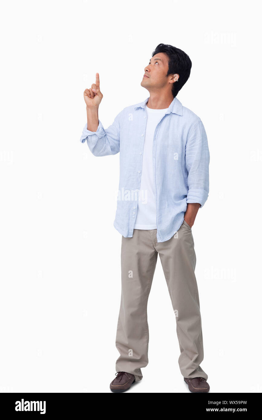 Male pointing and looking up against a white background Stock Photo - Alamy
