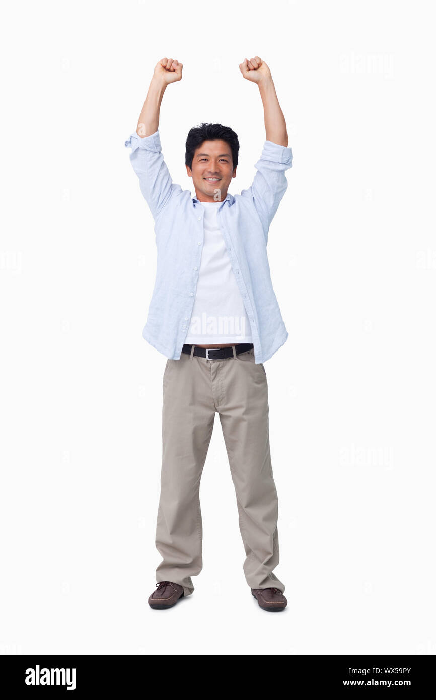 Cheering male with arms up against a white background Stock Photo - Alamy