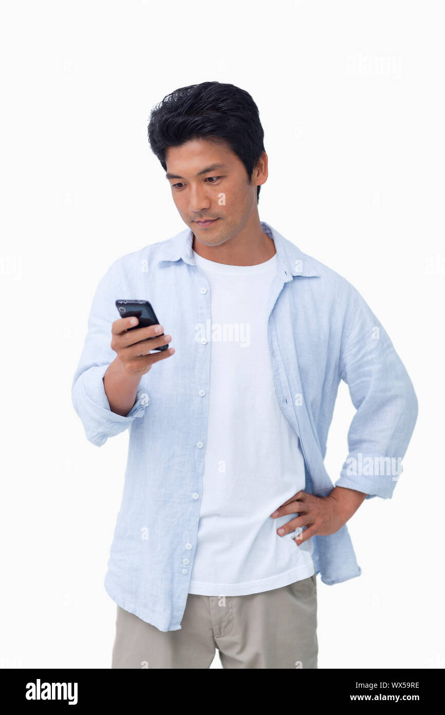 Male typing text message against a white background Stock Photo - Alamy