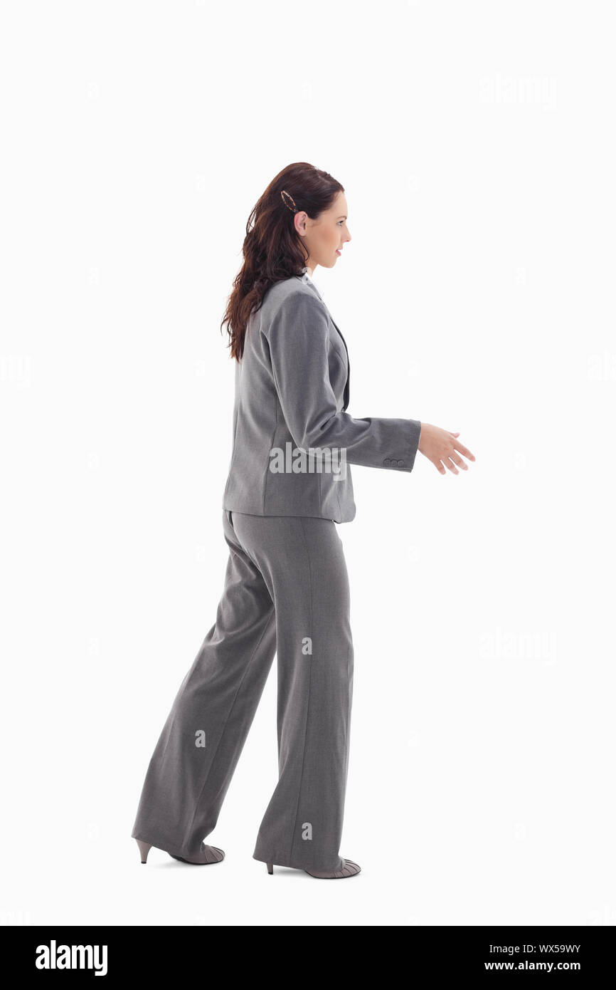 Businesswoman shaking a hand against white background Stock Photo - Alamy
