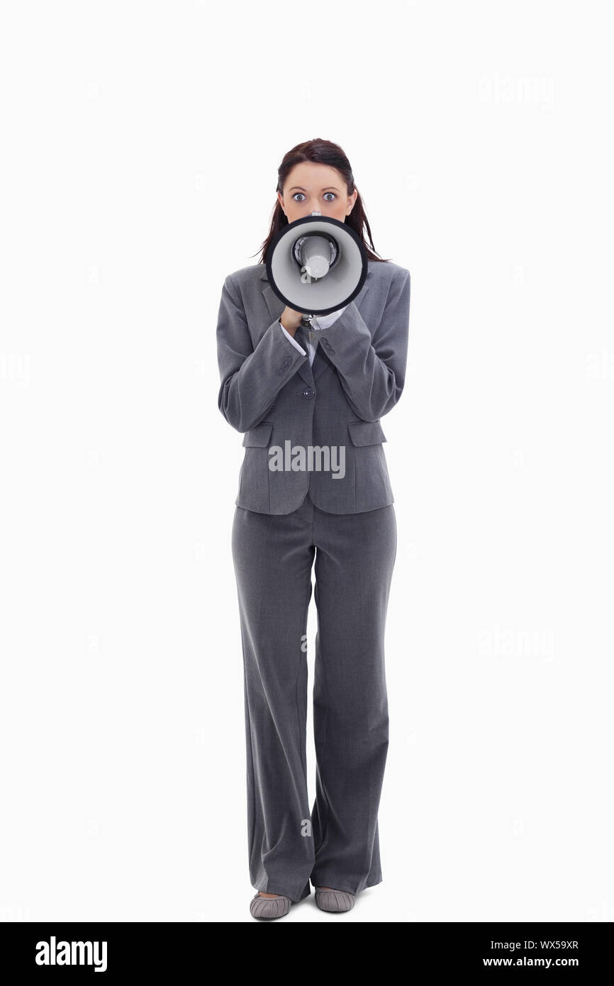 Expressive businesswoman speaking in a megaphone against white ...