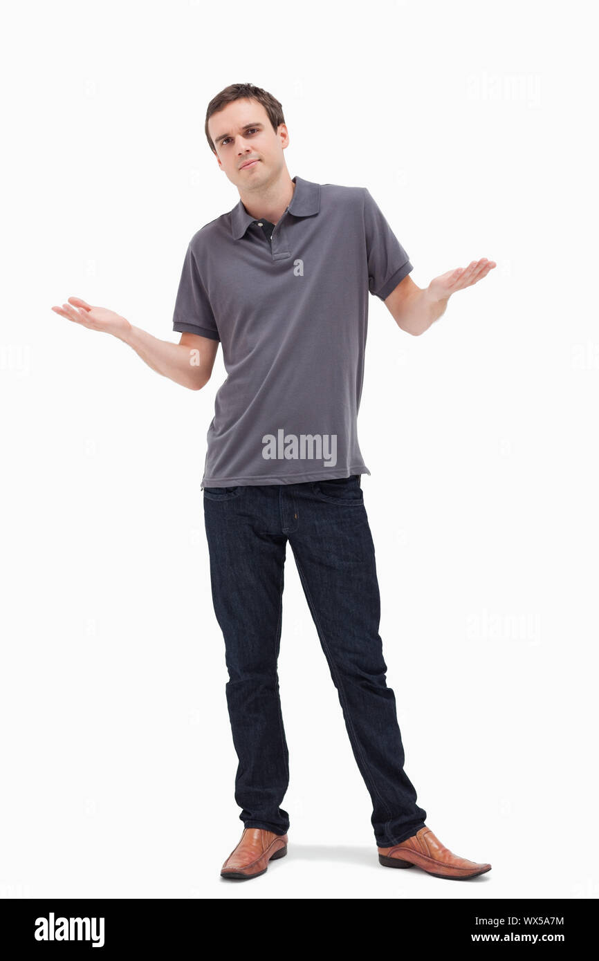 Man shrugging his shoulders against white background Stock Photo - Alamy