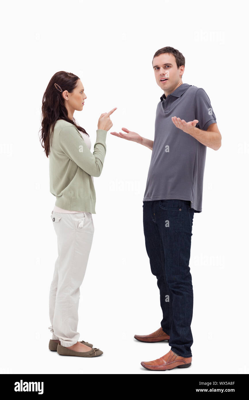 Man shrugged his shoulders is scolded by woman against white background ...