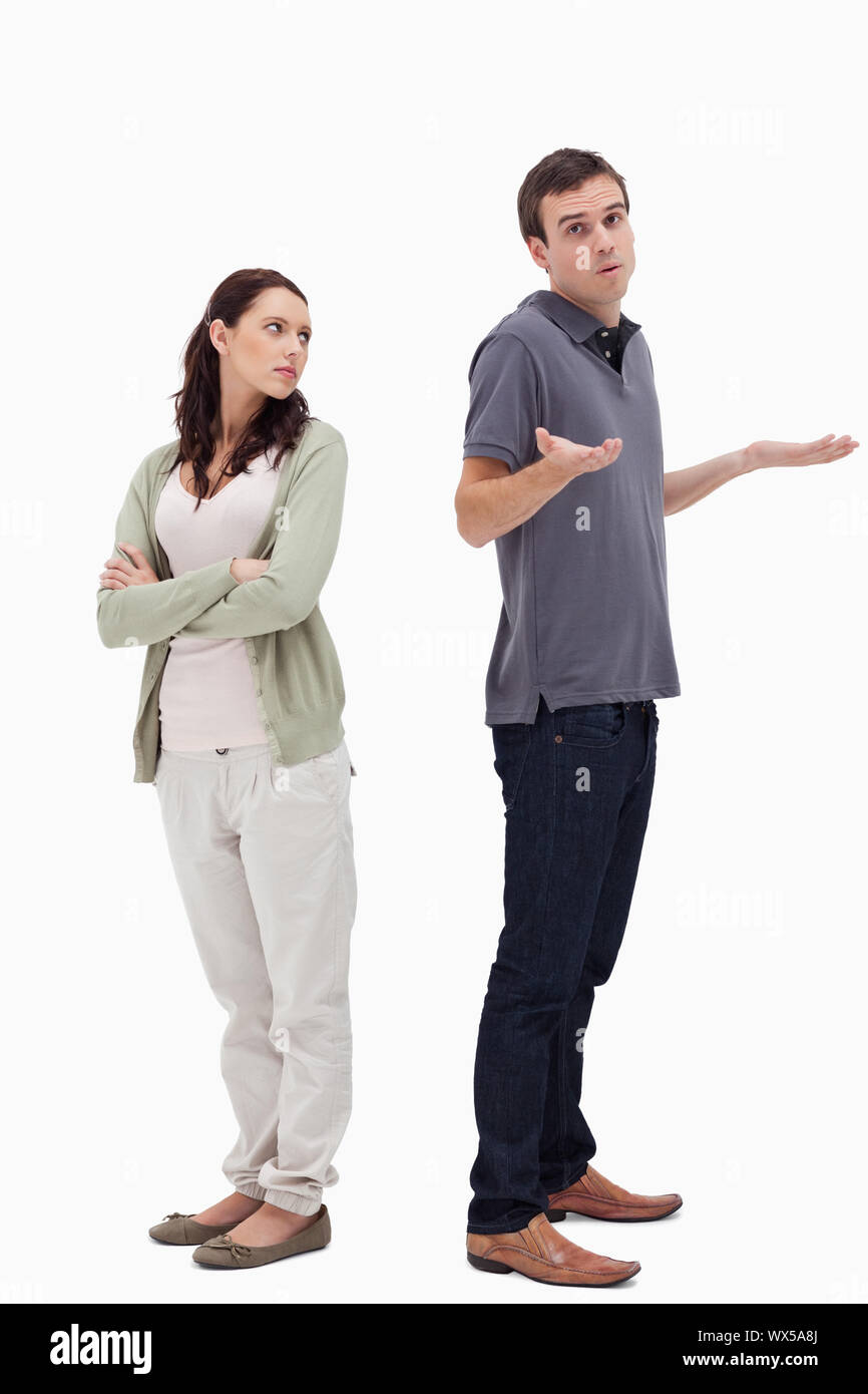 Man shrugged his shoulders back to back with angry woman against white ...