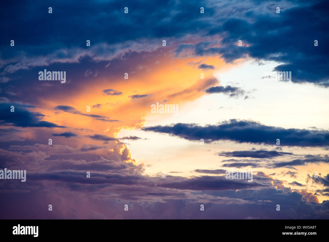 Beautiful sunset illuminates dramatic cloudscape with storm clouds in ...