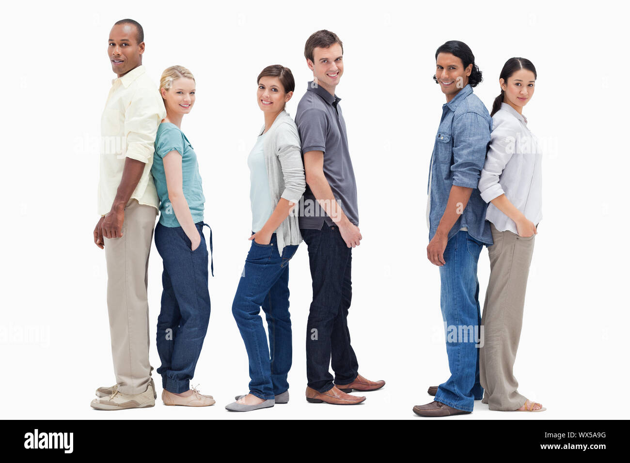 Three friends standing side by side against black background Cut Out ...