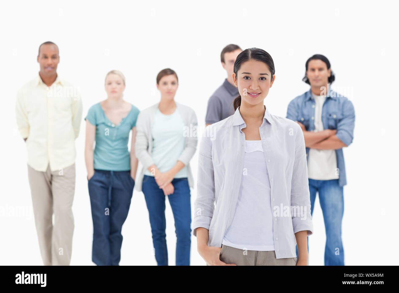 People behind a woman smiling against white background Stock Photo - Alamy