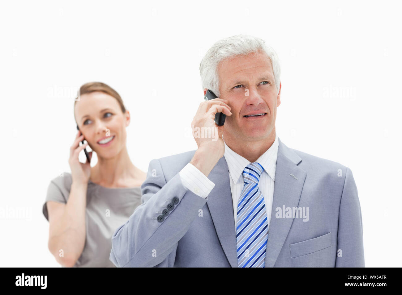 Close-up of a white man hair man dressed in a suit talking on the phone ...