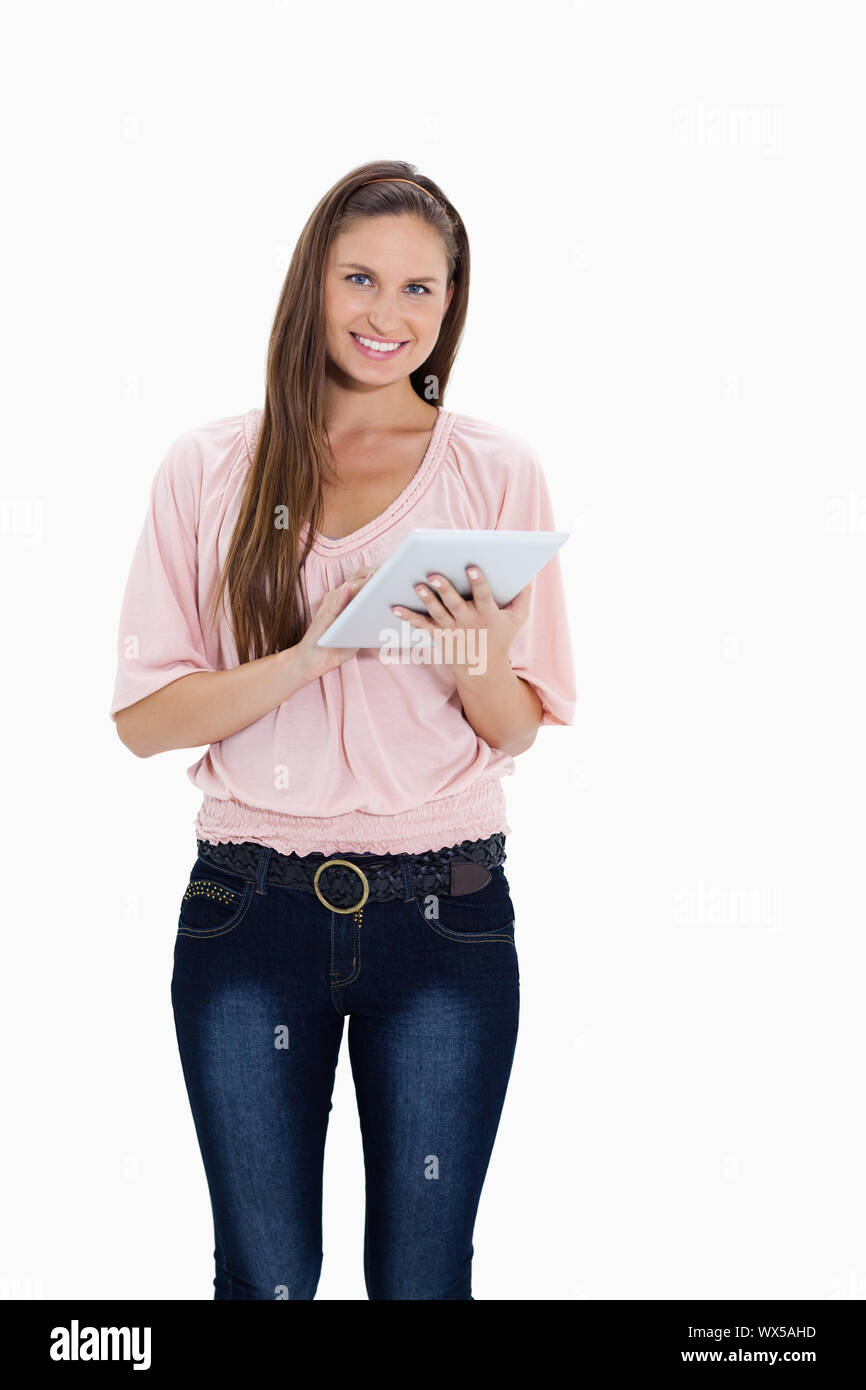Smiling girl using a touchpad against white background Stock Photo - Alamy