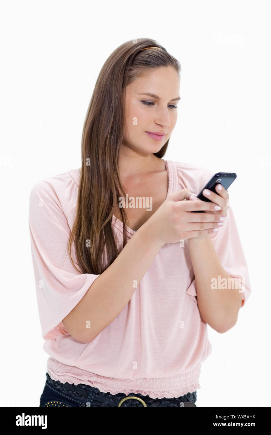 Close-up of a girl typing a text message against white background Stock ...