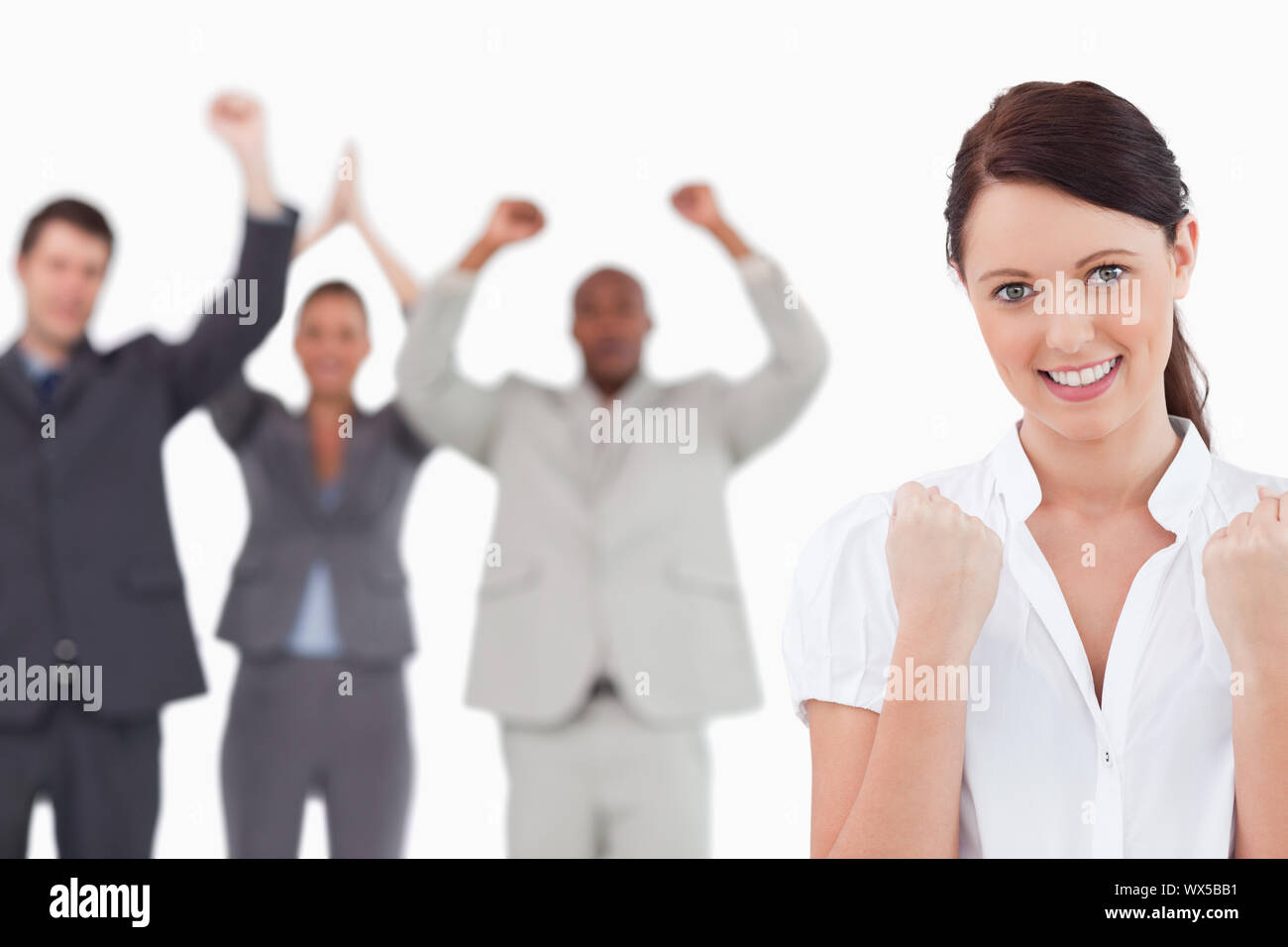 Successful businesswoman with cheering co-workers behind her Stock ...