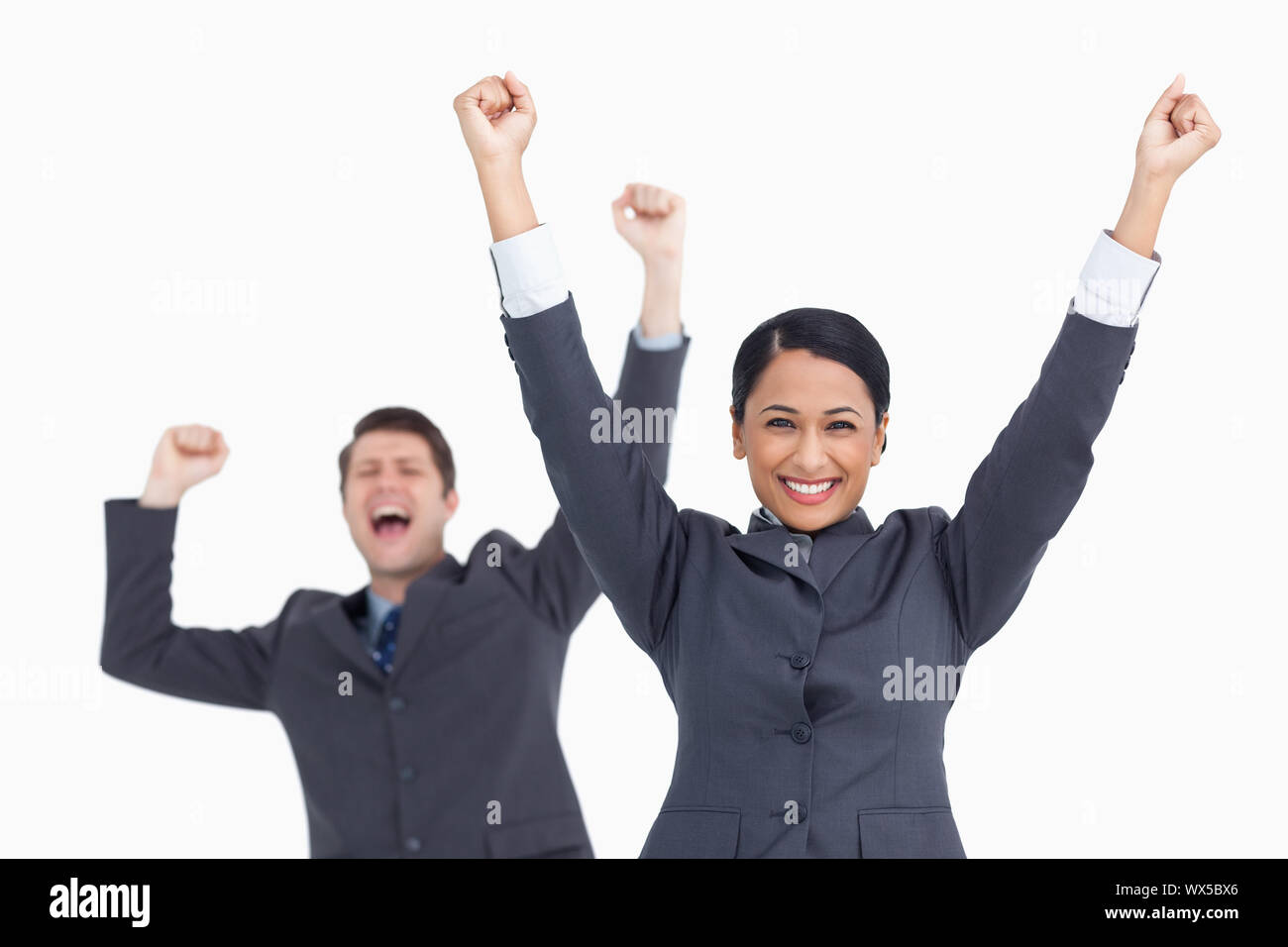 Close up of successful salesteam cheering against a white background ...
