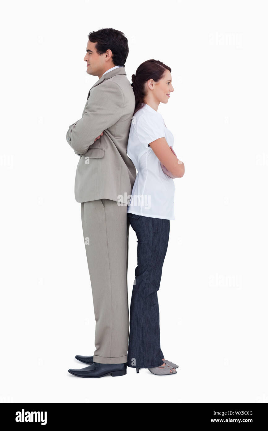 Salesteam standing back to back against a white background Stock Photo ...