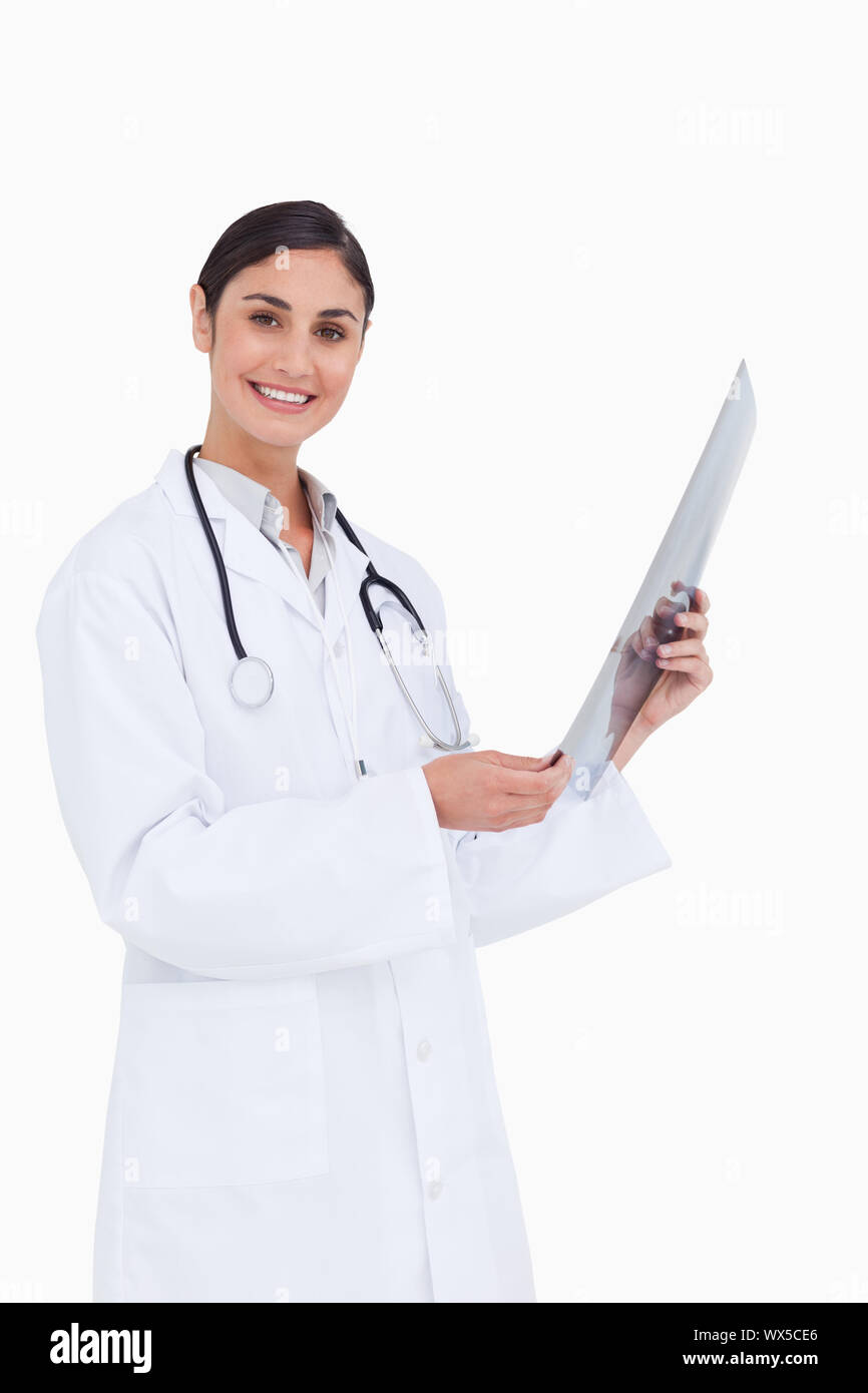 Side view of smiling female doctor with x-ray against a white ...
