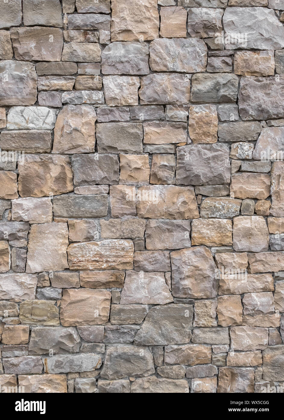 Decorative and irregular stone wall Stock Photo - Alamy