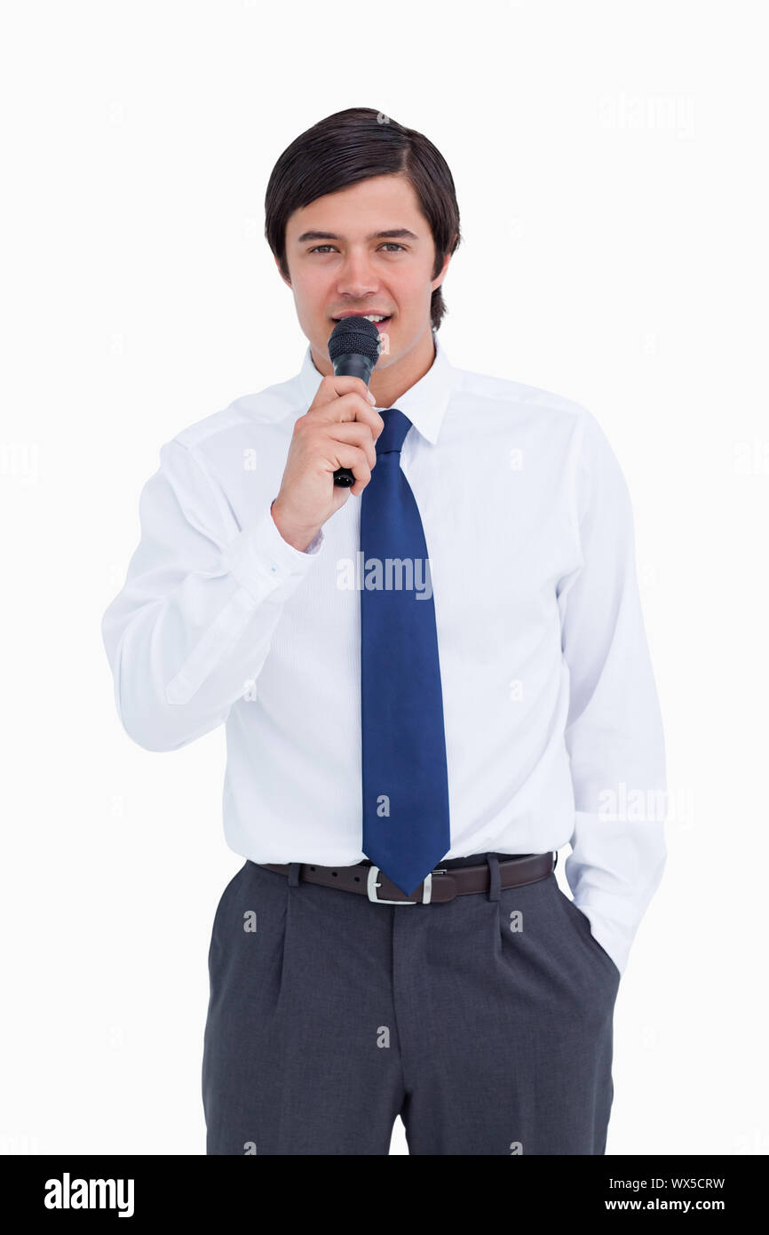 Young tradesman talking with microphone against a white background Stock Photo - Alamy