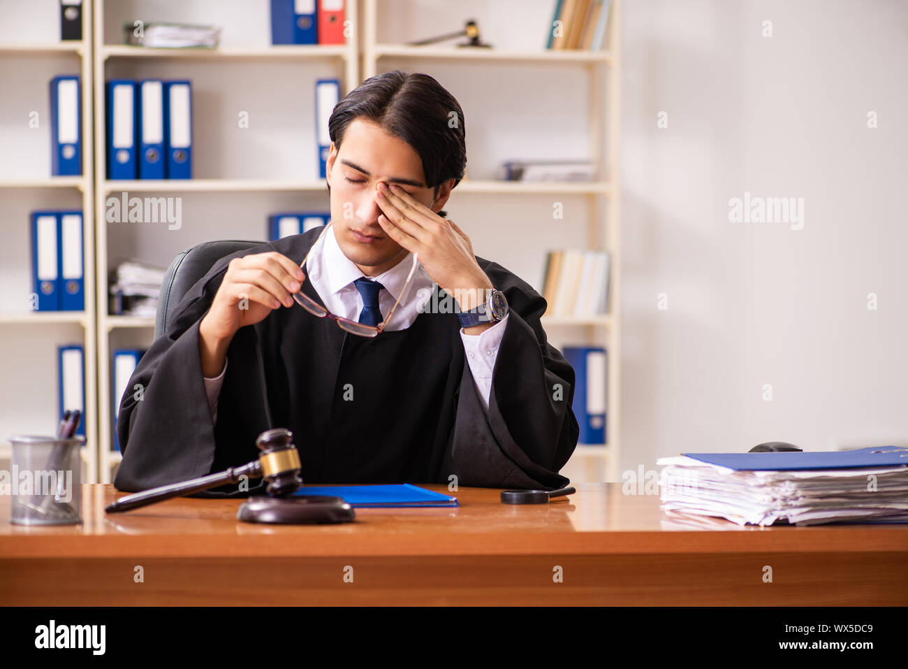 Young handsome judge working in court Stock Photo - Alamy