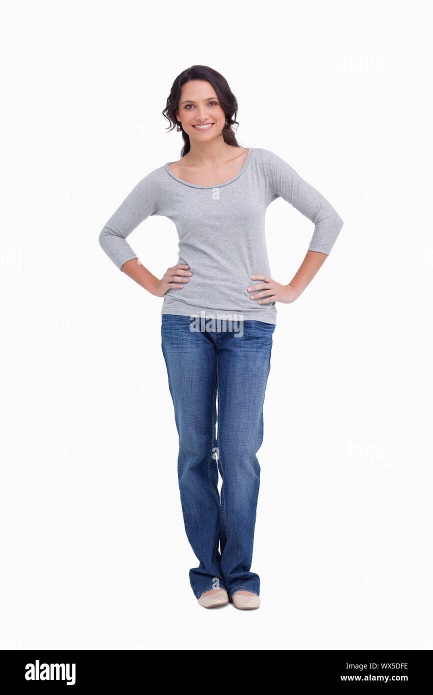 Smiling woman with hands on her hip against a white background Stock ...