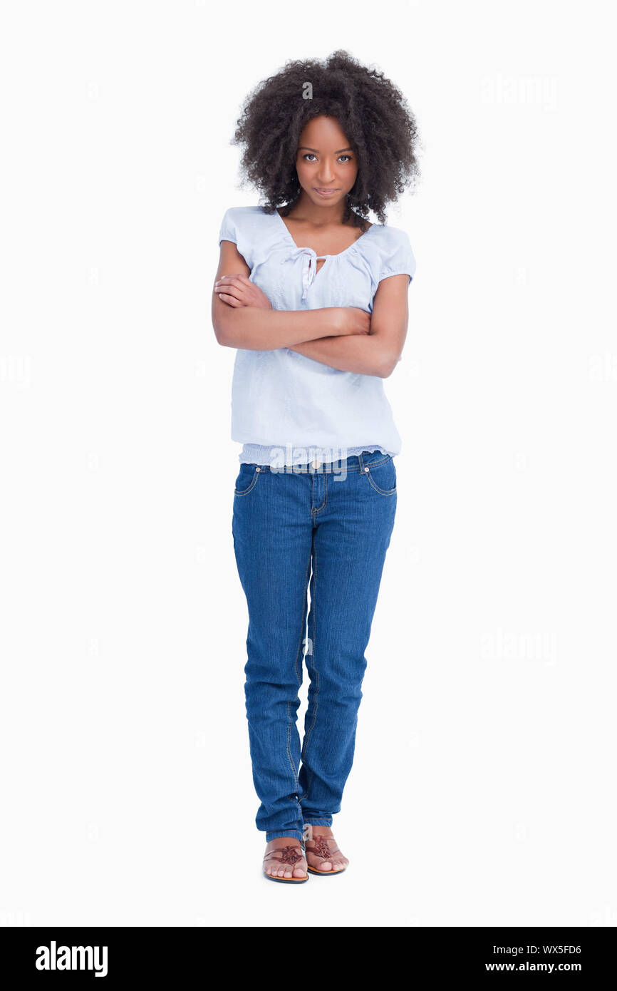Young serious woman crossing her arms against a white background Stock ...