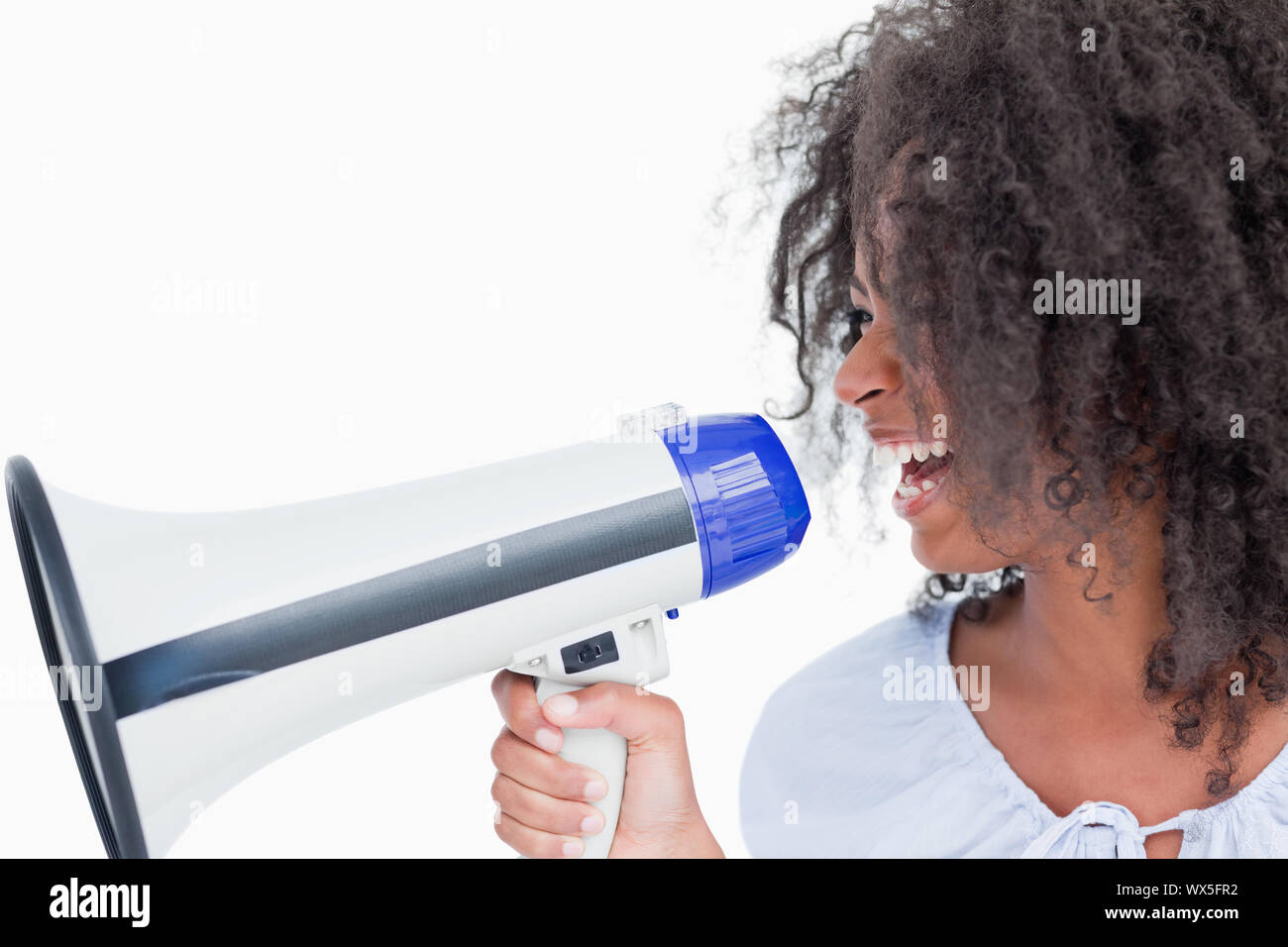 Young woman talking into a megaphone against a white background Stock ...