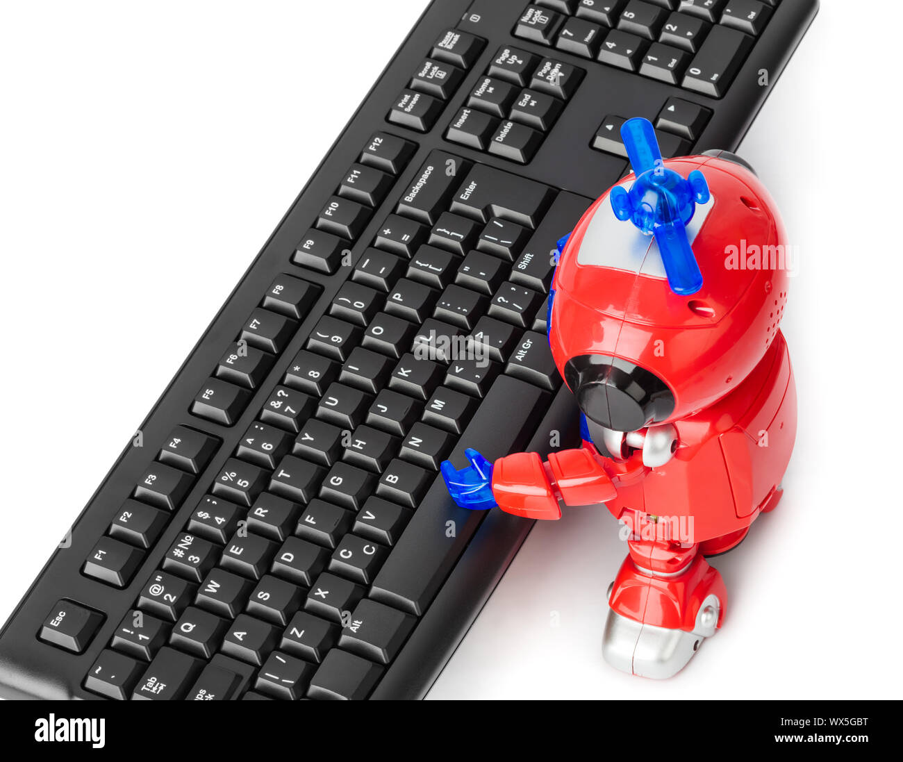 Toy robot and computer Stock Photo - Alamy