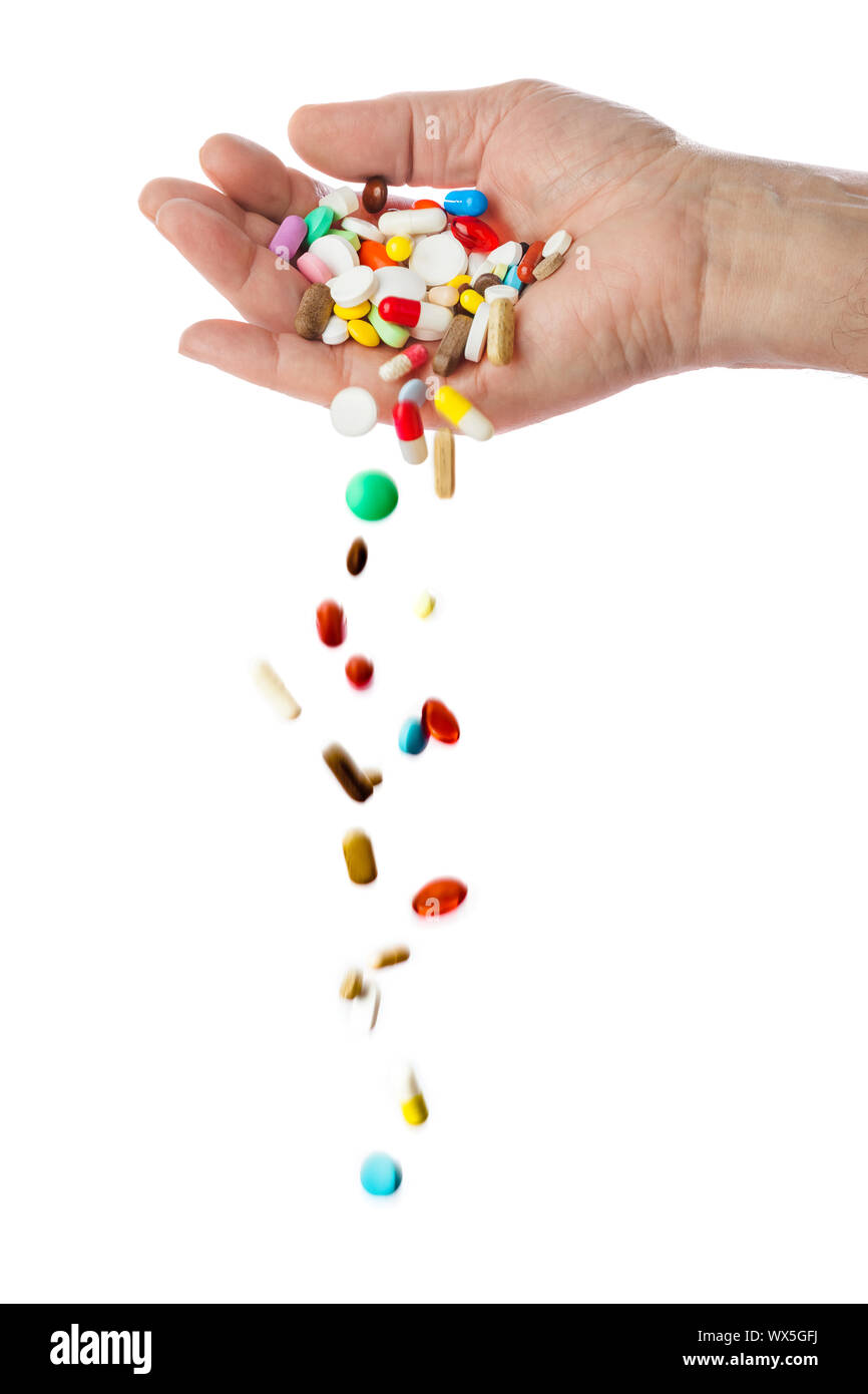 Hand and falling pills Stock Photo - Alamy