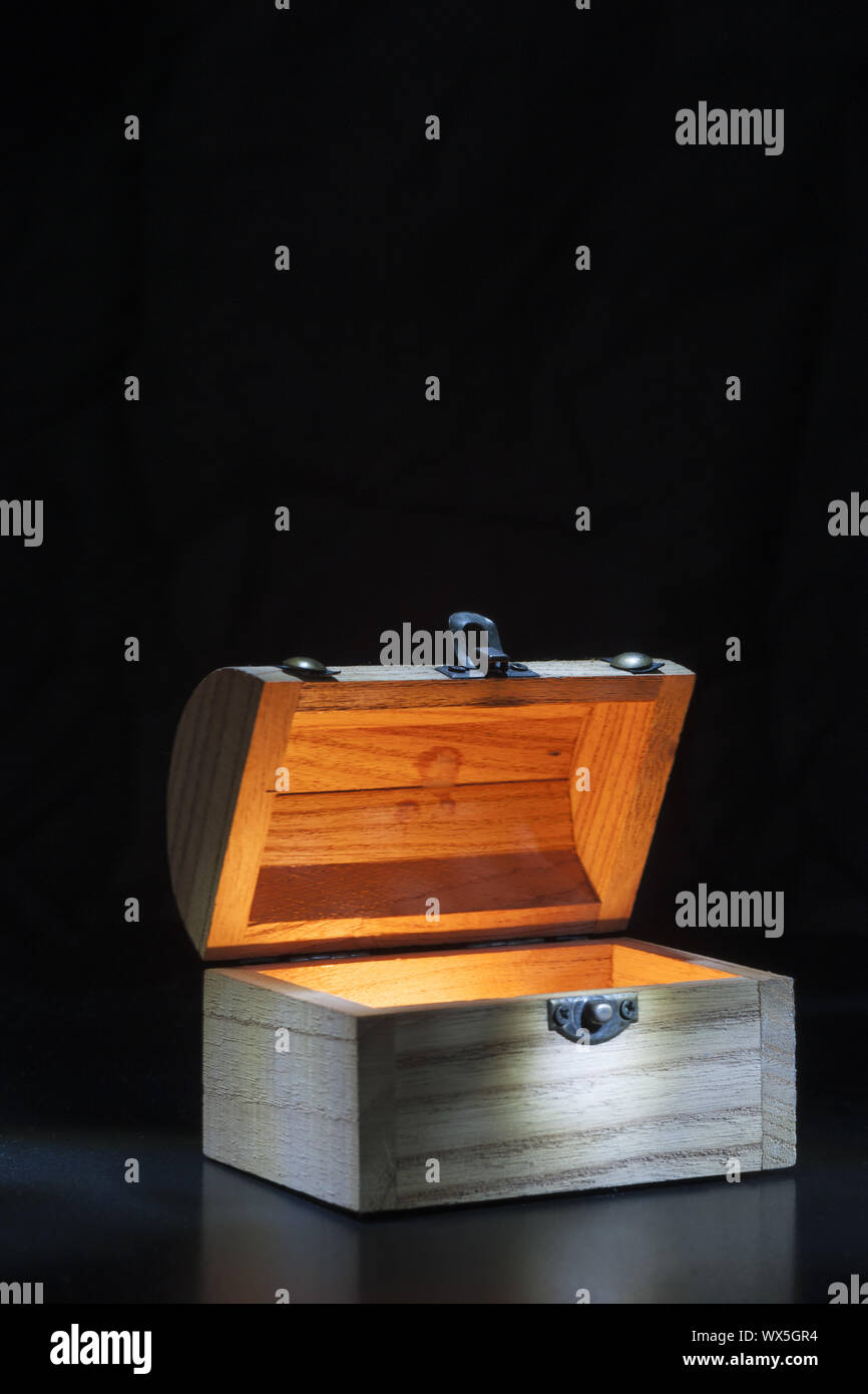 small treasure chest with spot light Stock Photo - Alamy