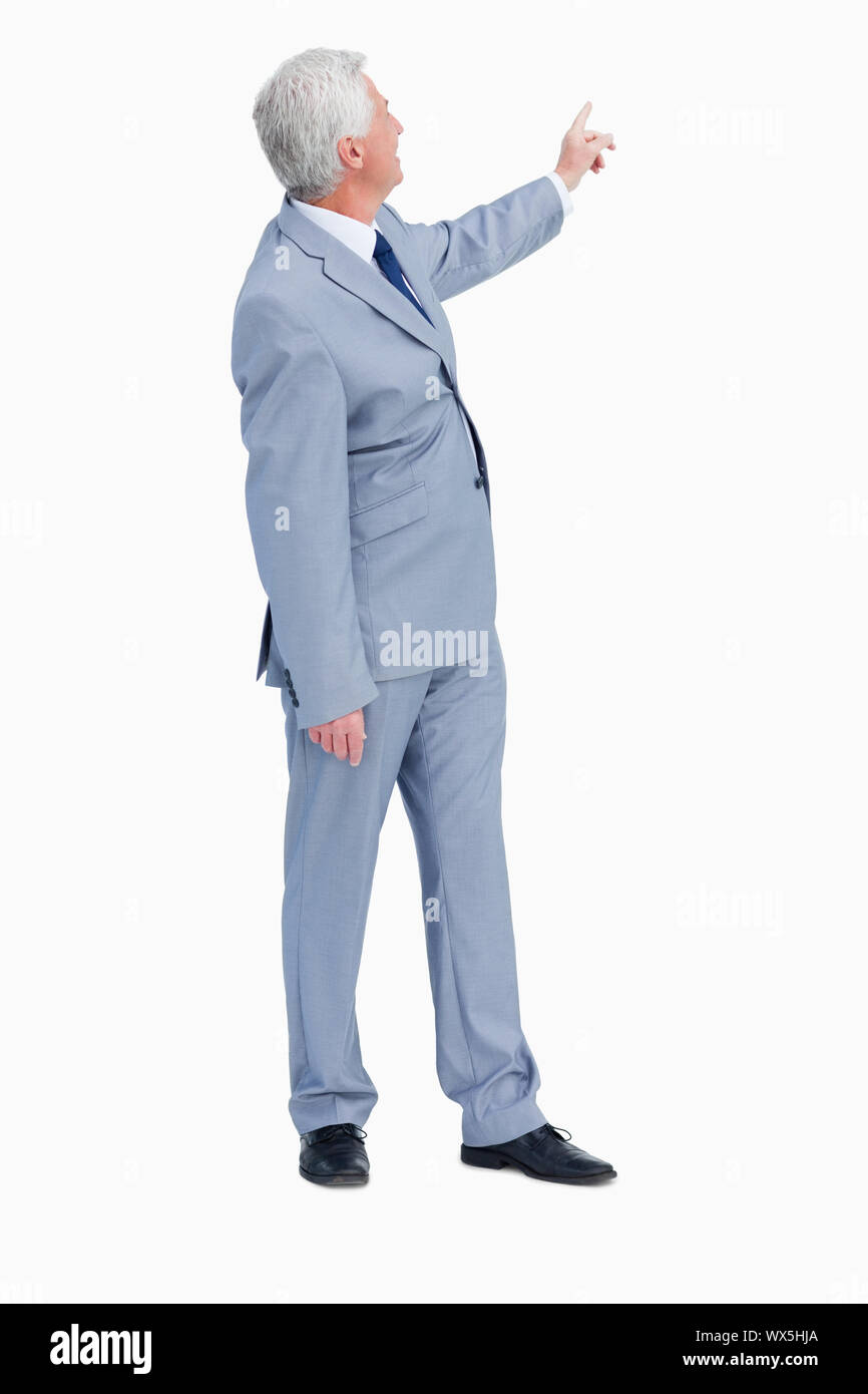 Businessman pointing behind him against white background Stock Photo ...