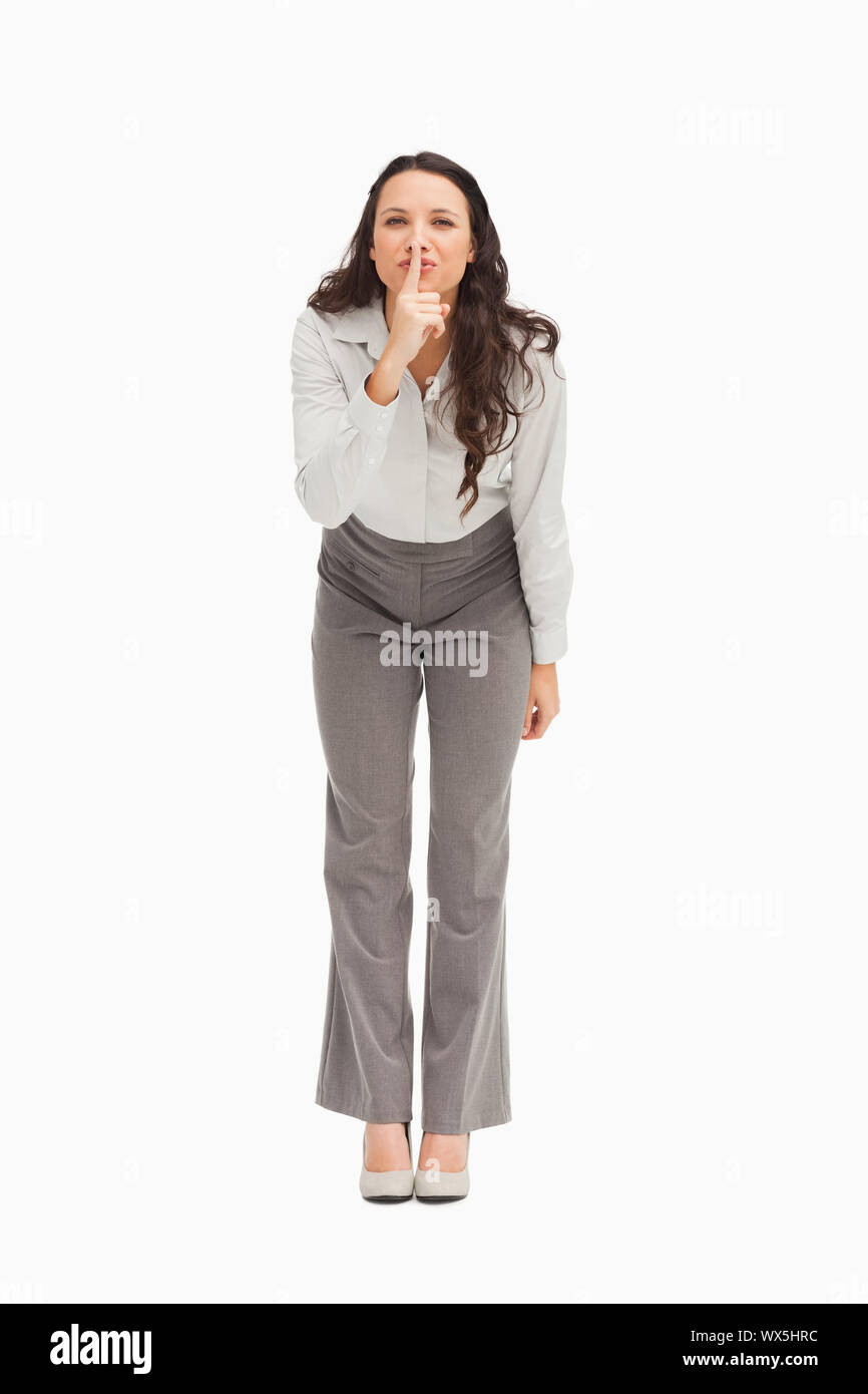 Portrait of an employee keeping a secret against white background Stock ...