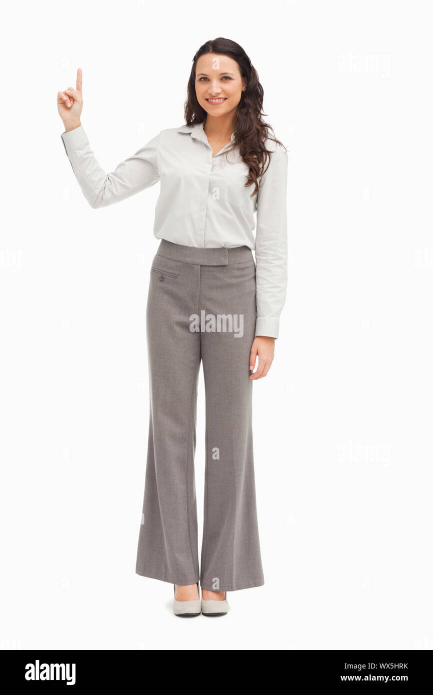 Portrait of an employee pointing up against white background Stock ...