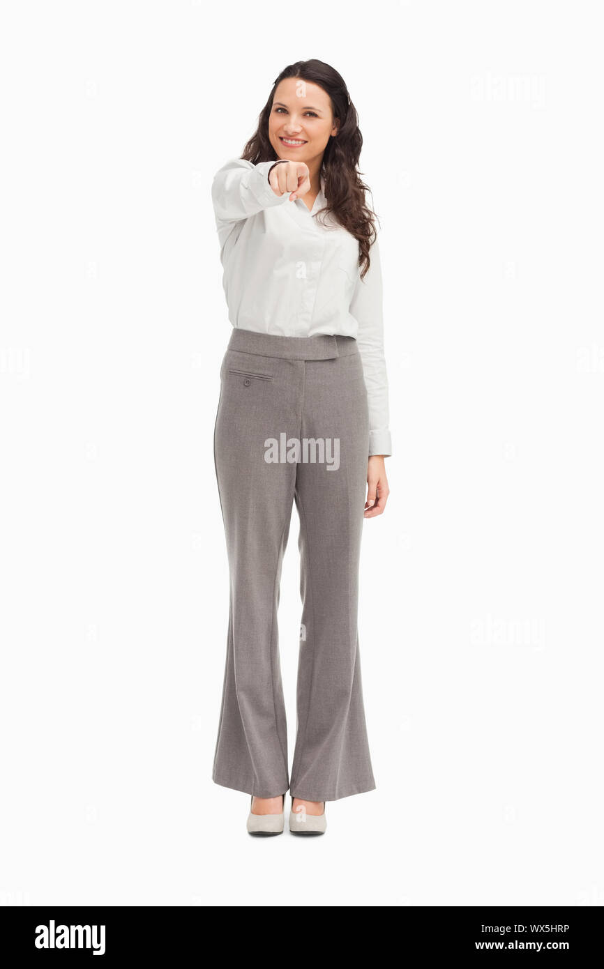 Portrait of a smiling employee pointing against white background Stock ...