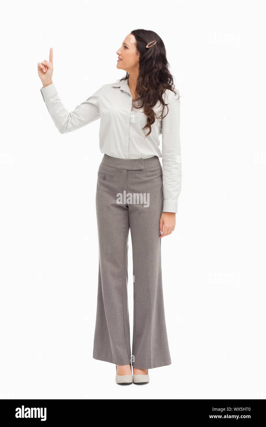 Employee pointing up against white background Stock Photo - Alamy