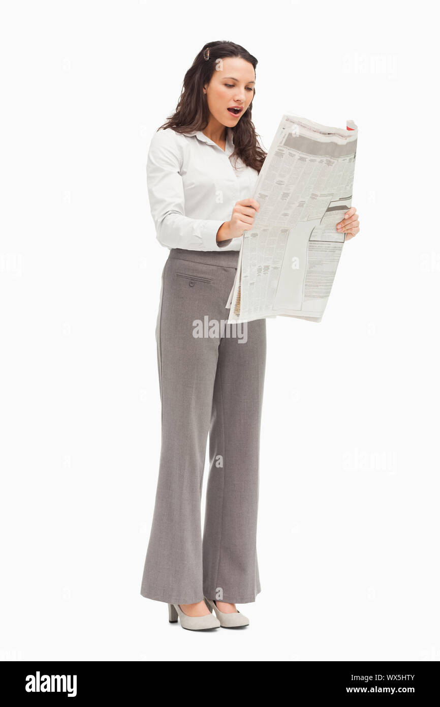 Employee surprised while reading the news against white background ...