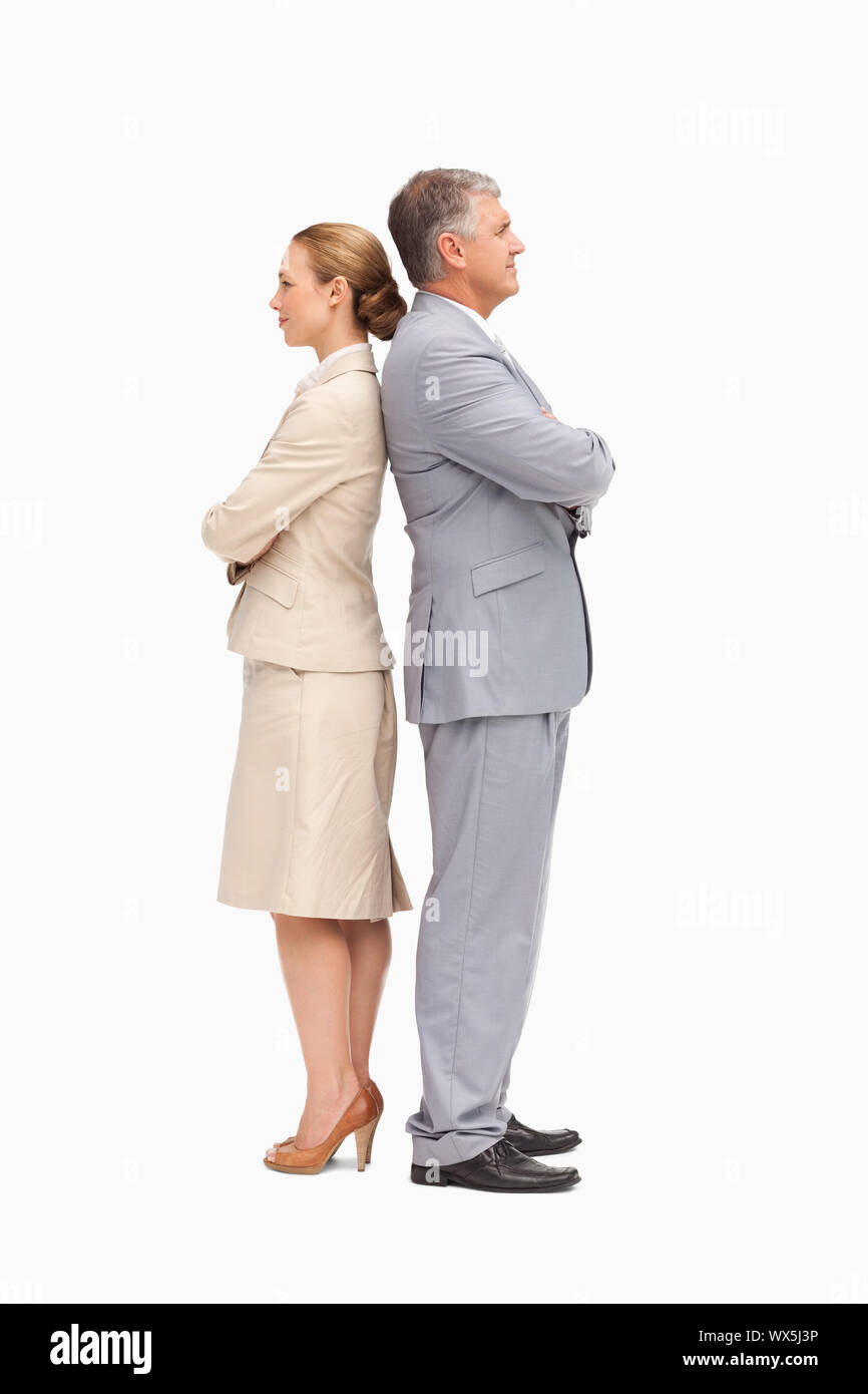 Business people with folded arms back to back against white background ...
