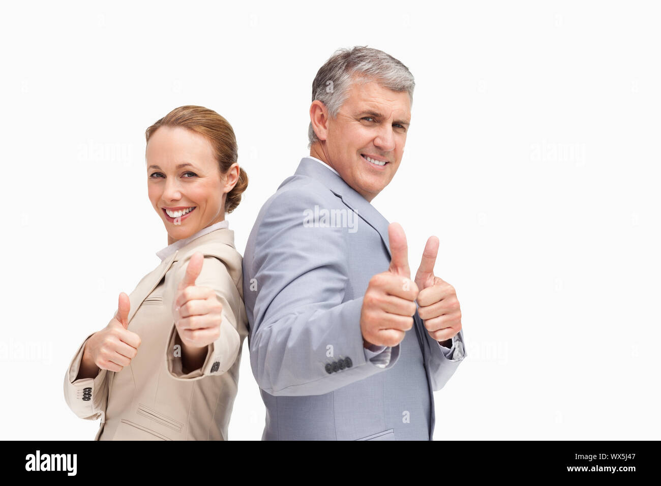 Portrait of business people approving back to back against white ...