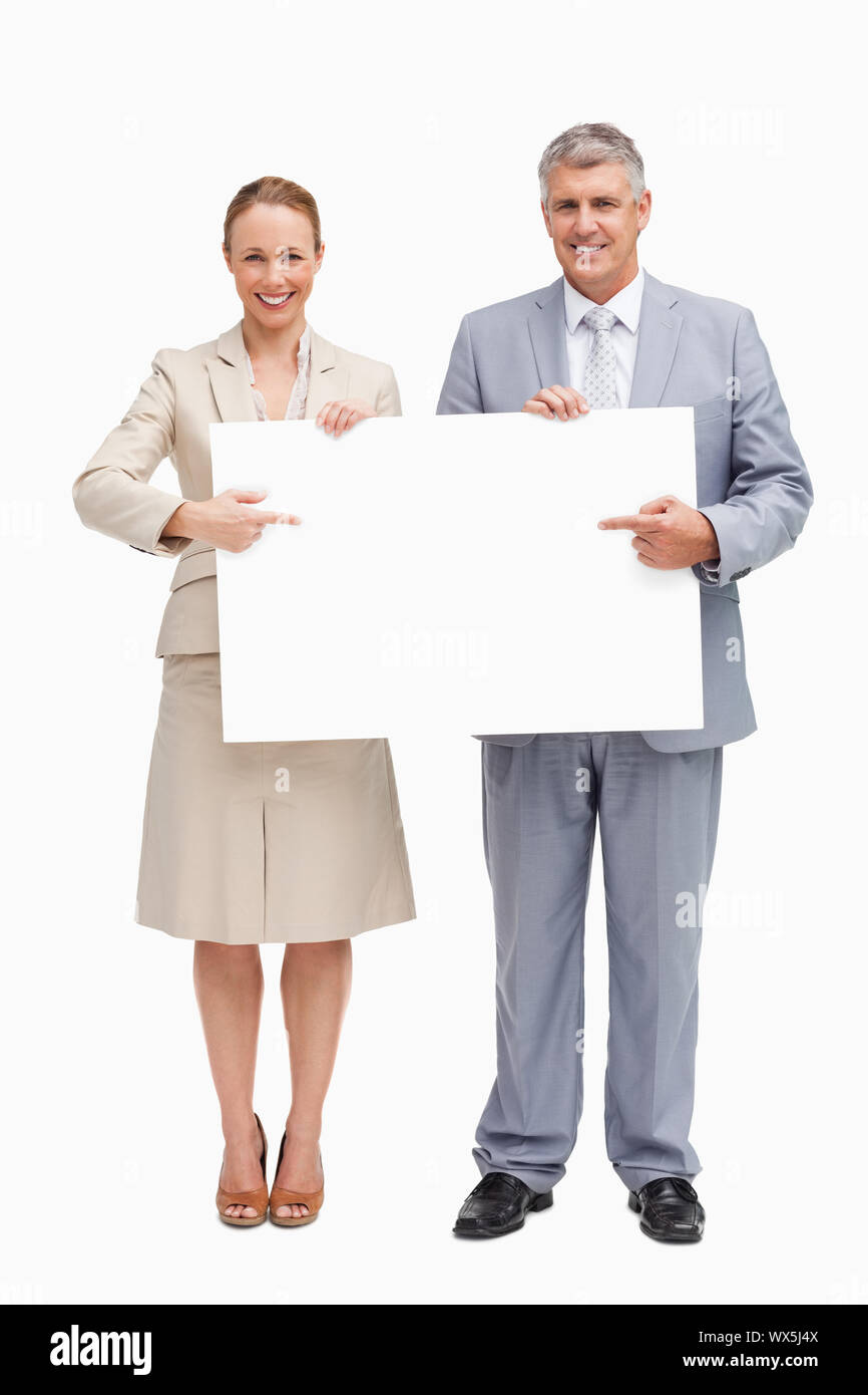 Business people showing a poster against white background Stock Photo ...