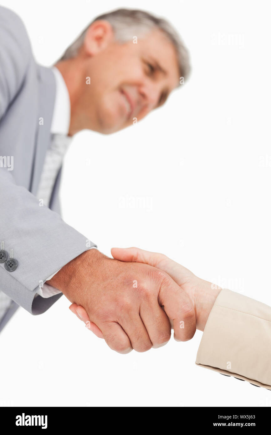 Low angle-shot of shake hands against white background Stock Photo - Alamy