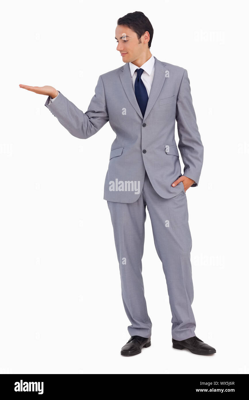 Good-looking man presenting with the hand against white background ...